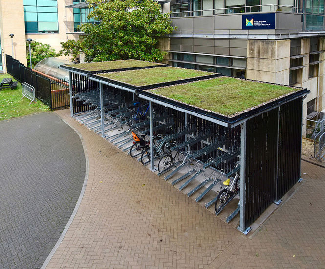 Green roof cycle shelter and 2-tier bike racks for university | Broxap