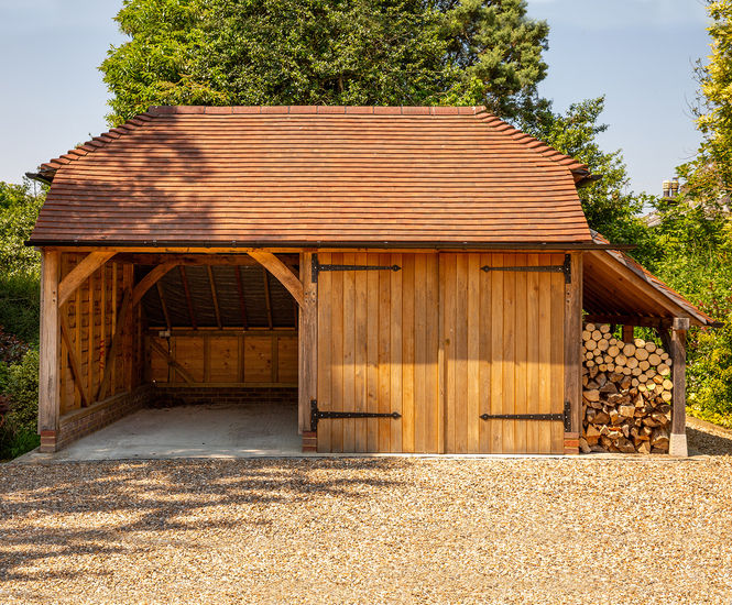 2 Bay oak framed garage kit with gable end and log store | Round Wood ...