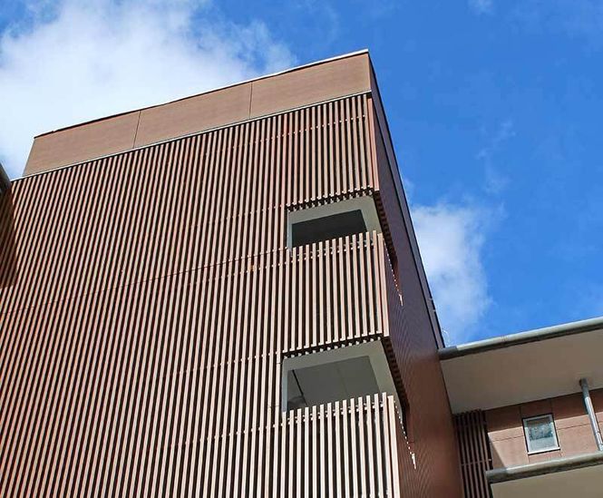 Timber cladding replaced by wood-effect aluminium system | Vulcan ...