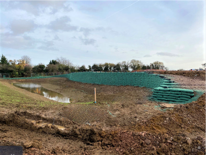 Earth reinforced retaining walls for attenuation ponds | GeoGrow | ESI ...