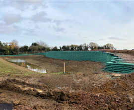 Earth reinforced retaining walls for attenuation ponds | GeoGrow | ESI ...